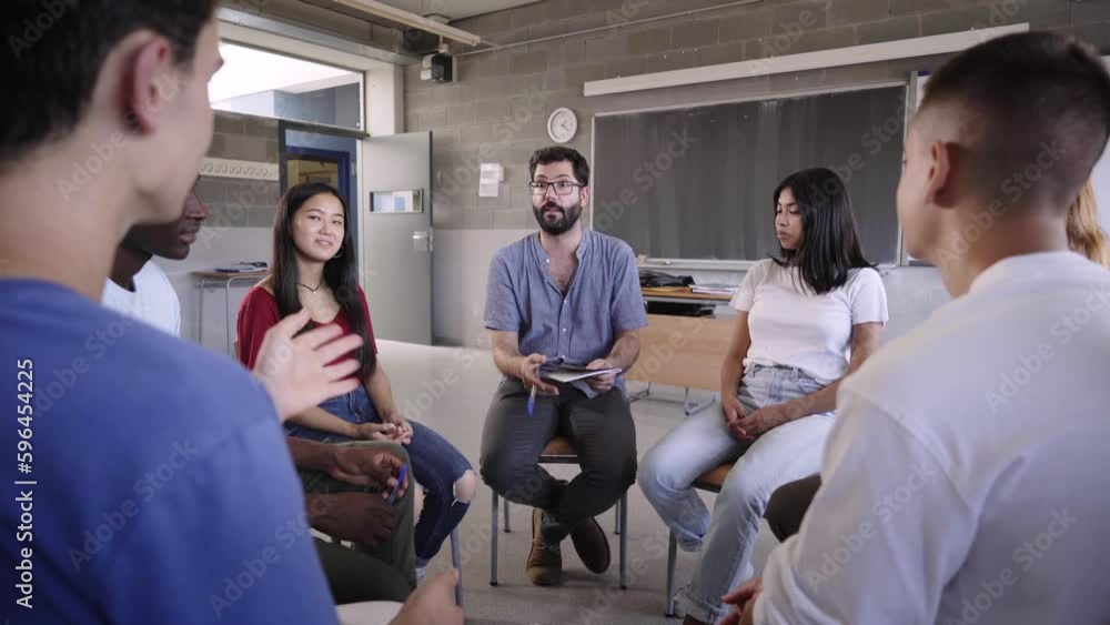 High school teacher teaching students subject matter of course ...