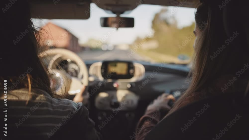 Couple driving in a car at sunset. Young Man and woman friends travel ...