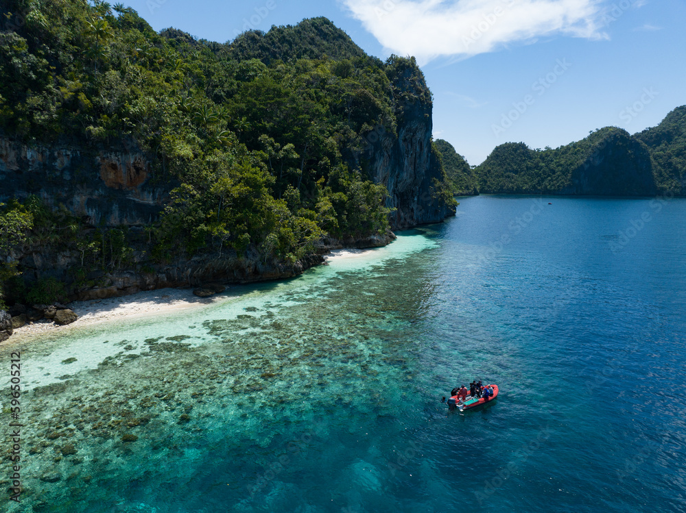 Beautiful coral reefs surround the dramatic limestone islands that rise ...