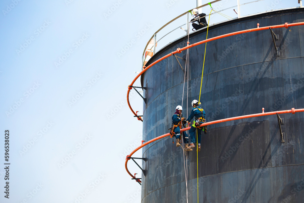 Male two worker rope down access safety inspection of pipe fire water ...