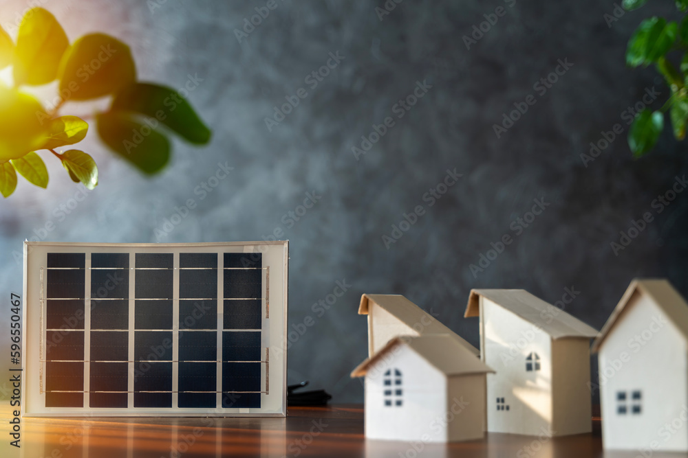Small cardboard house and solar panels close up. Free space to put text ...