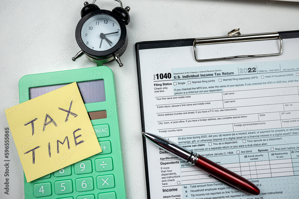 2022 blank us 1040 tax form with clock memo tax time and pen on office ...