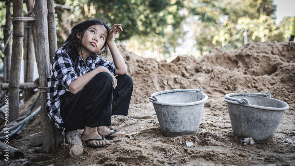 Exhausted little girl sitting construction background. child labor and ...