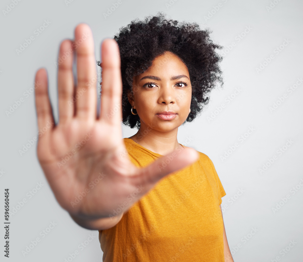 Portrait, palm and warning with a woman in studio on a gray background ...