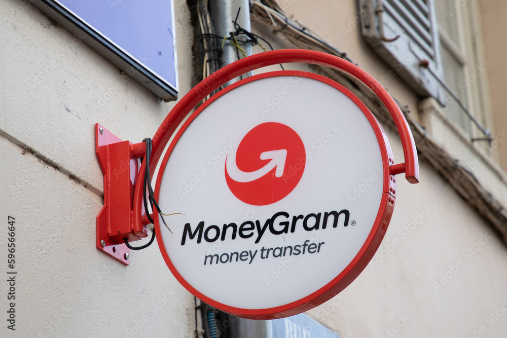 MoneyGram brand money transfer sign text and logo front wall facade ...