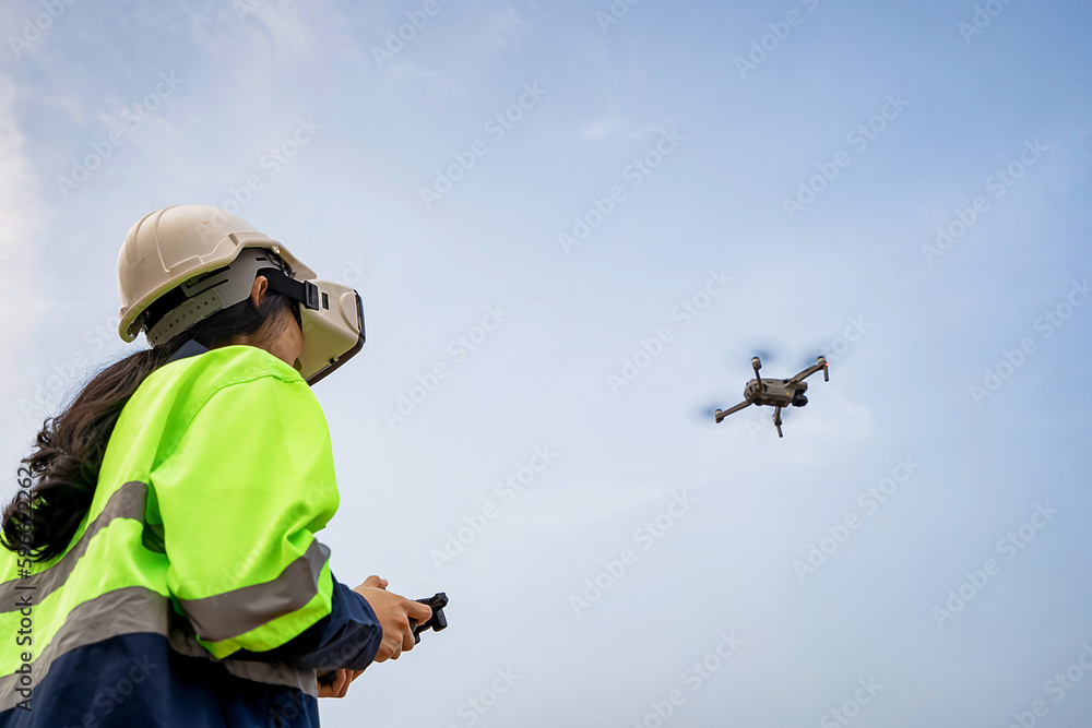 Asian female electrical engineer working inspecting power station near ...