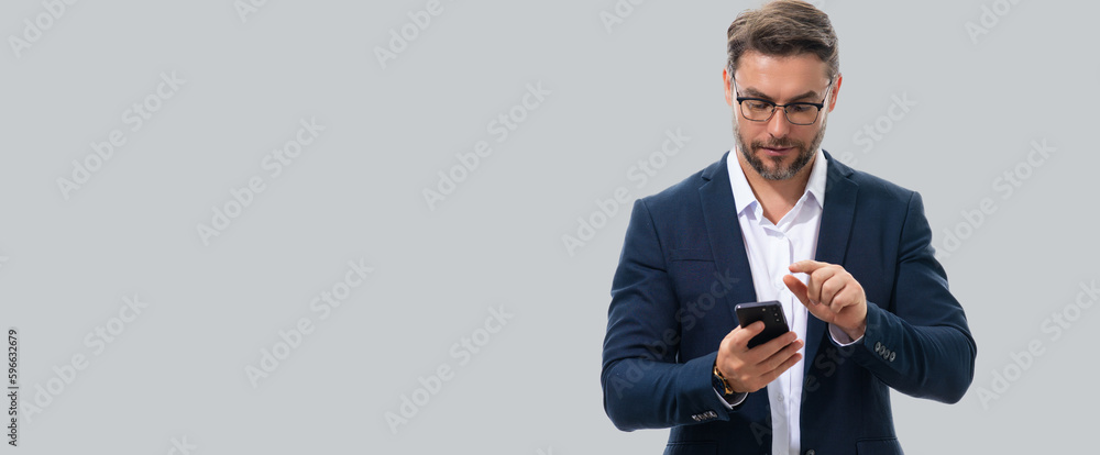 European business man in formal suit watching on mobile phone. Handsome ...