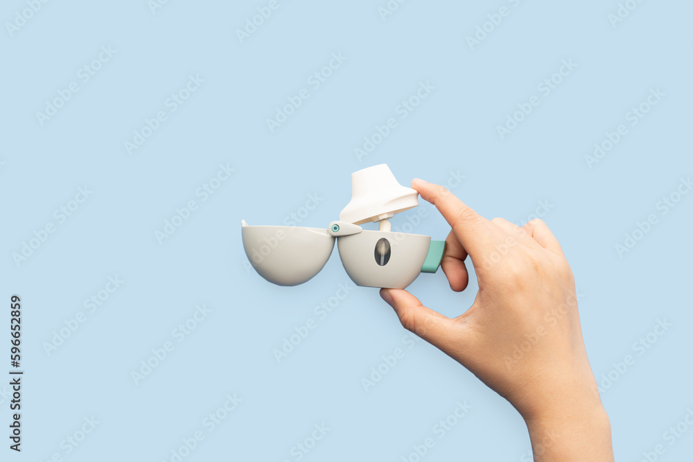 Prepare asthma inhaler for use. Woman hands put Tiotropium bromide ...