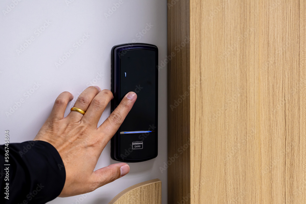 Hand in put password key to unlock door system in hotel. Entrance door ...