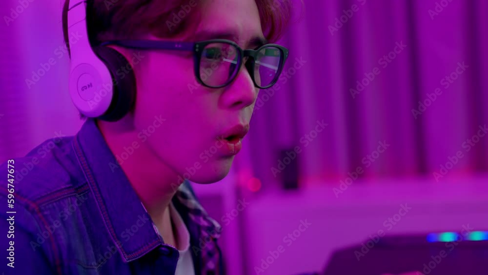 Close up portrait of asian young Gamer man with headphones excited ...