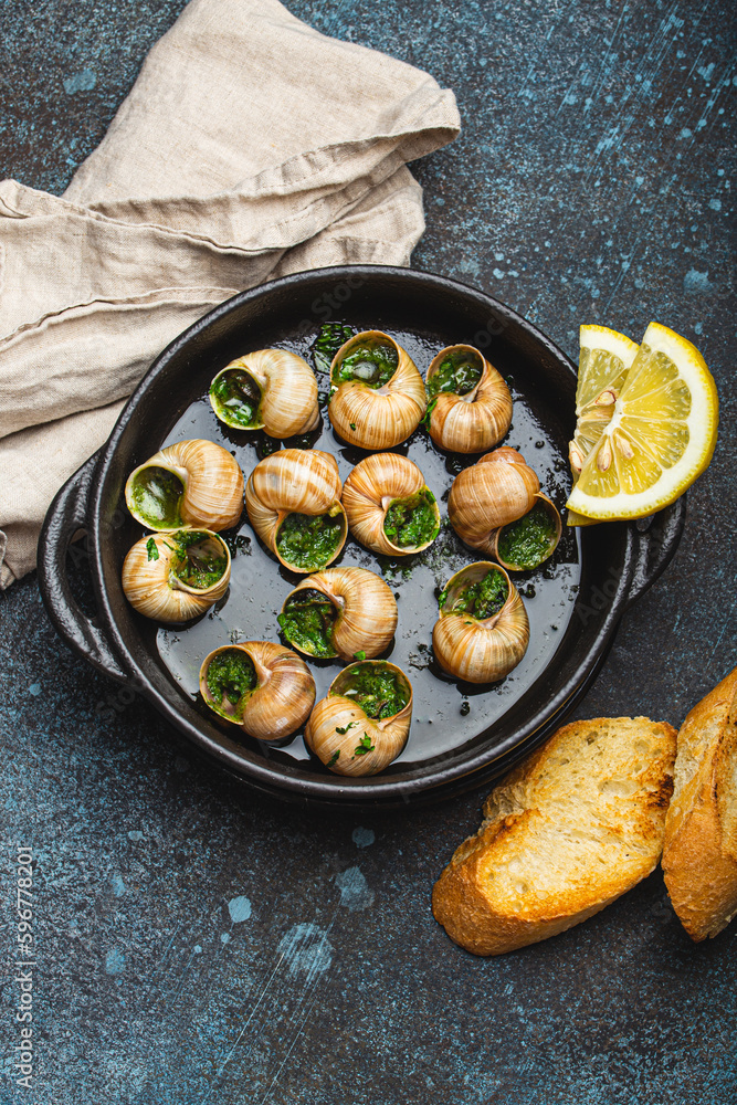 Escargots de Bourgogne Snails with Garlic Butter and Parsley in black ...