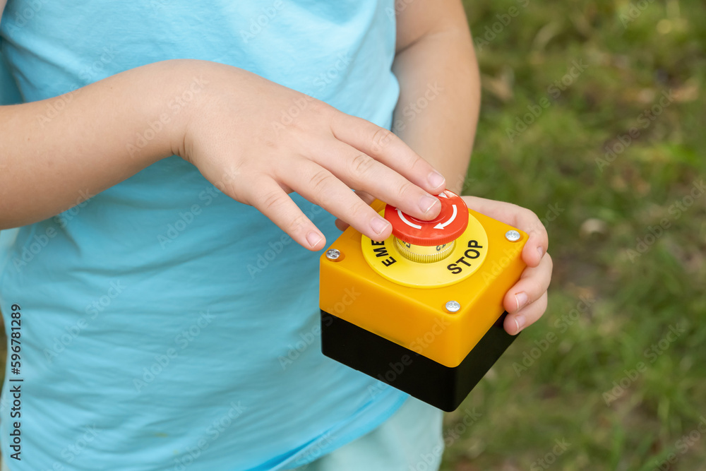 Anonymous elementary school age girl, child pressing a large red ...