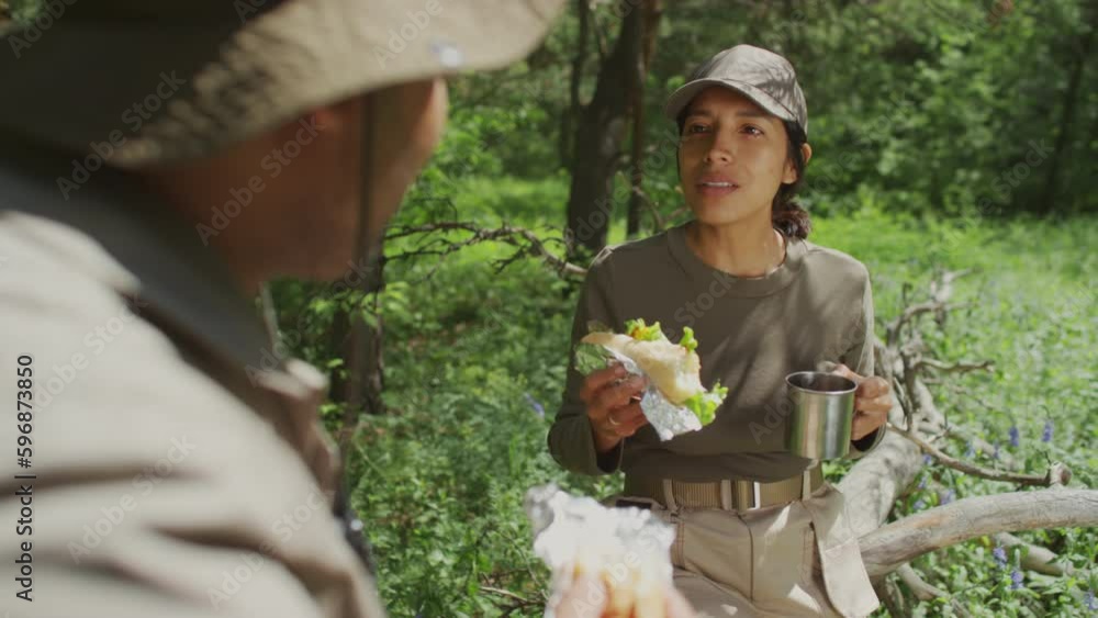 Medium over-shoulder shot of young Hispanic female forest ranger in ...