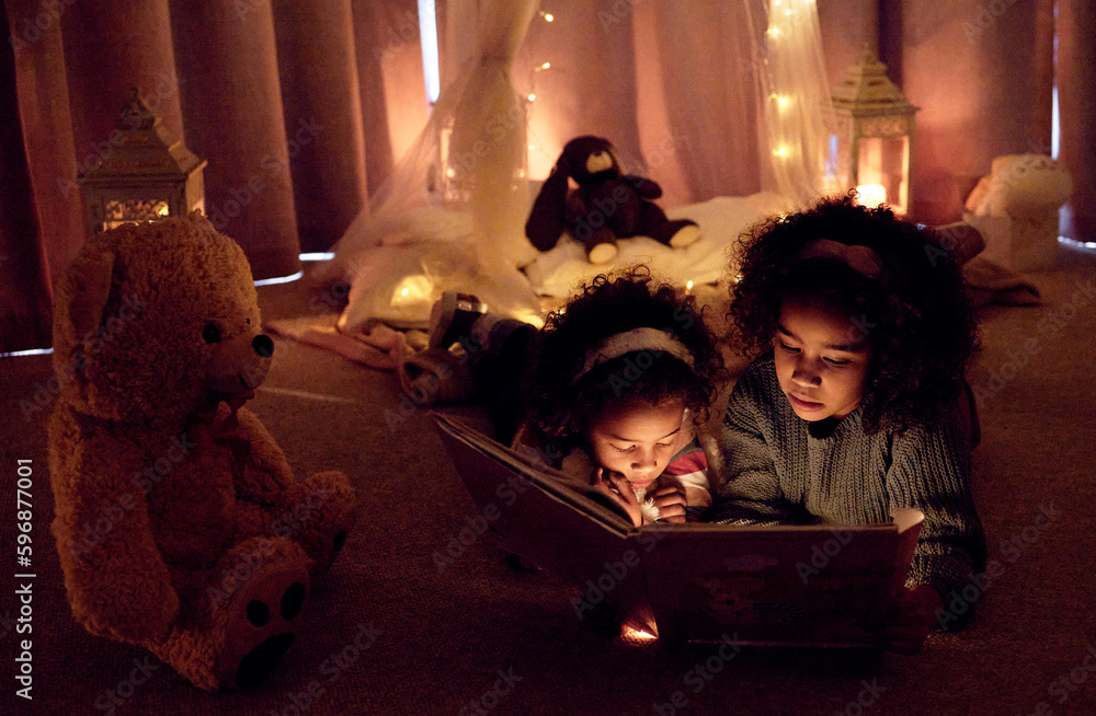 Open your mind, open a book. Shot of two adorable little girls reading ...
