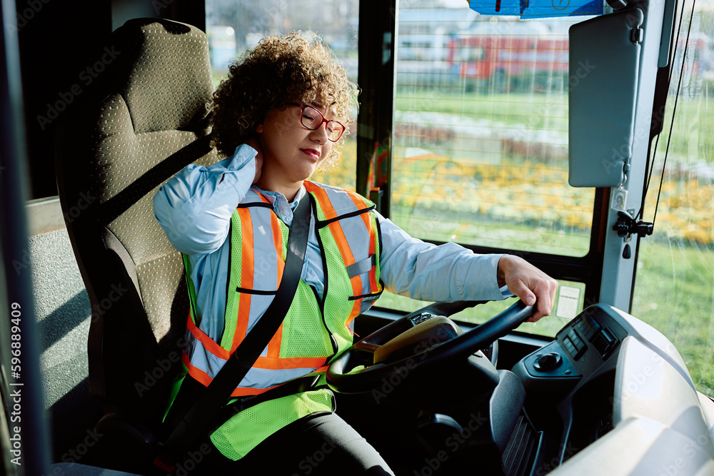 Female bus driver having neck pain while driving. Stock Photo | Adobe Stock