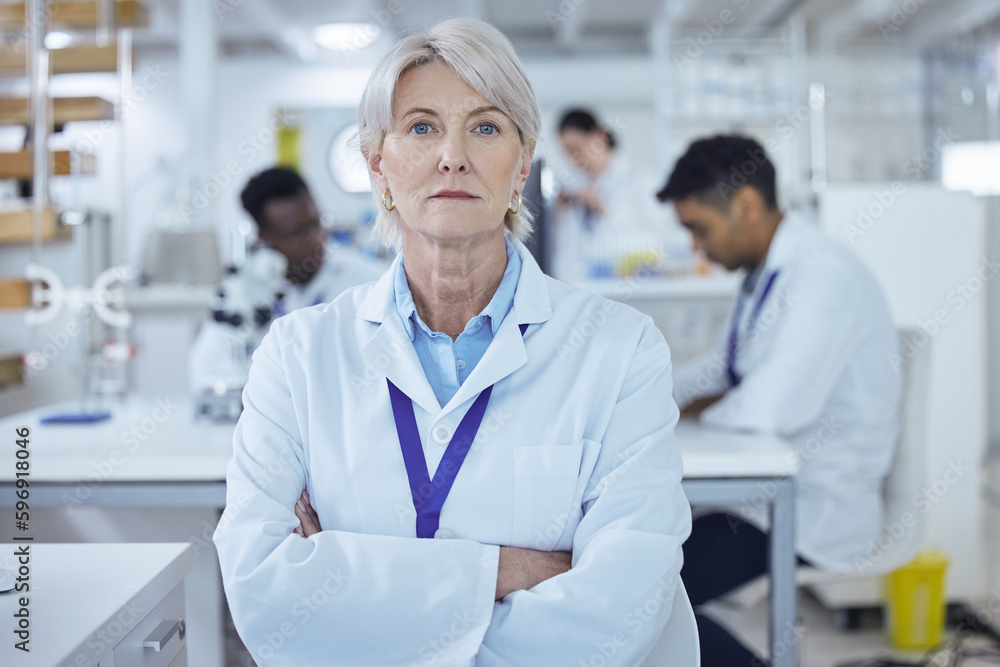 Ready to get to work. Shot of a proud mature female scientist in the ...
