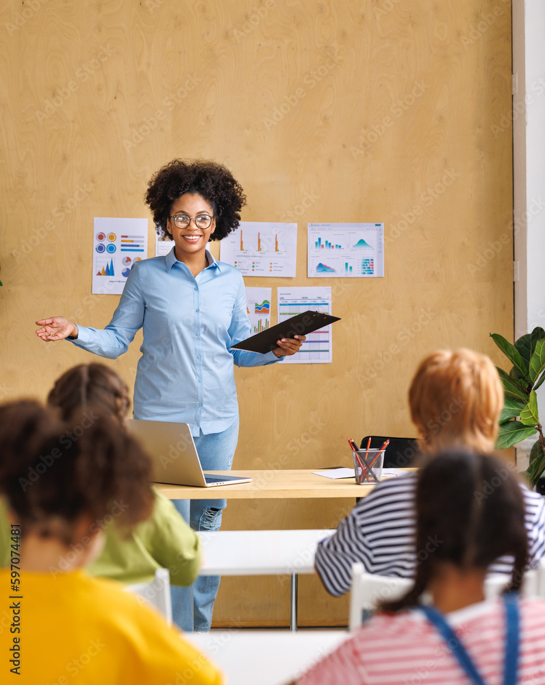 Teacher conducts a lesson, gives a lecture children during school work ...