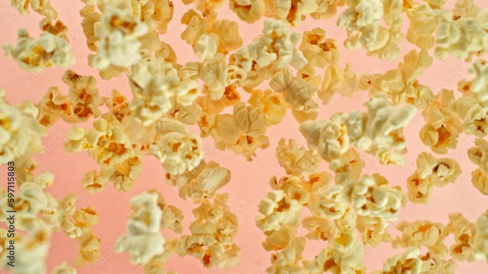 Super slow motion of rotating popcorn in the air. Isolated on colored ...