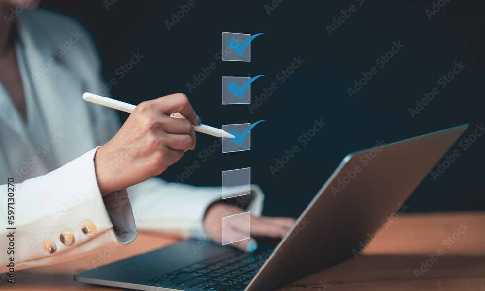 Businesswoman using laptop doing online checklist survey, Business ...