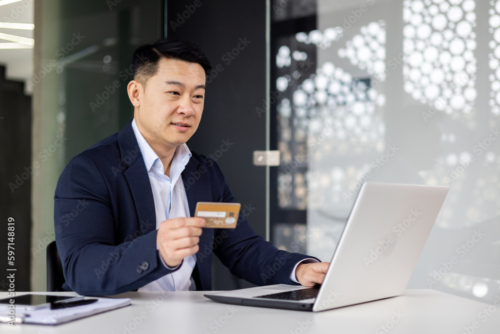 Fotografia do Stock: Successful Asian businessman works inside office ...