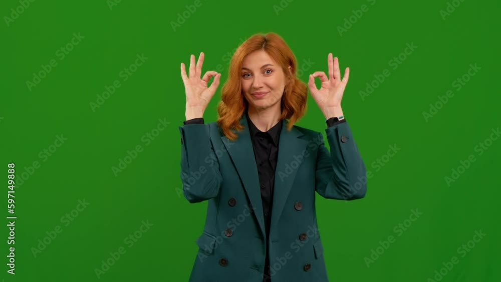 Positive smiling woman on green screen background showing double okey ...
