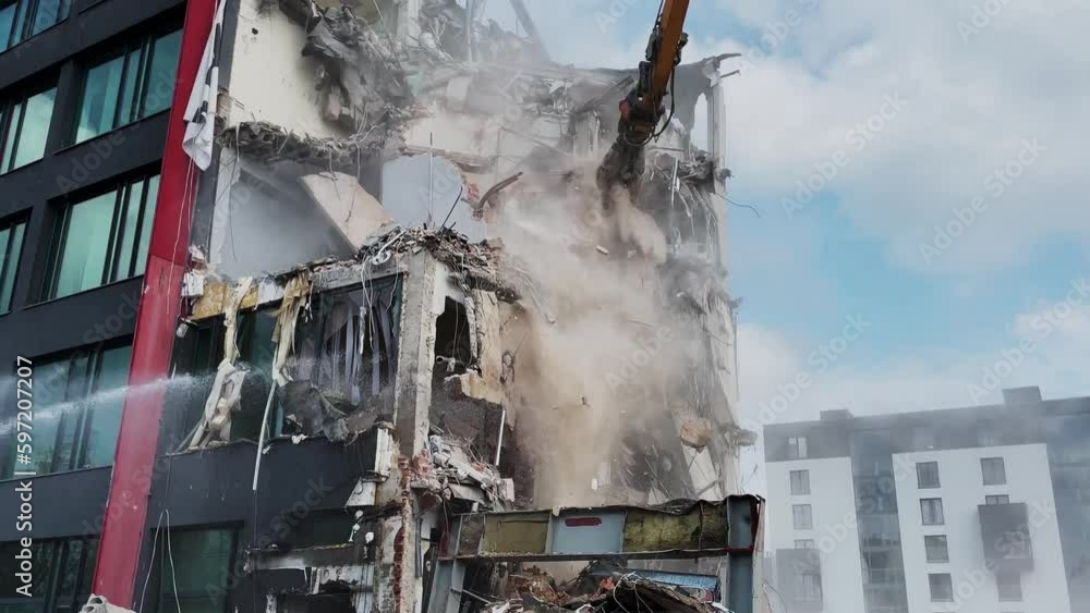 Rebuilding the city. Construction equipment demolishes an office block ...