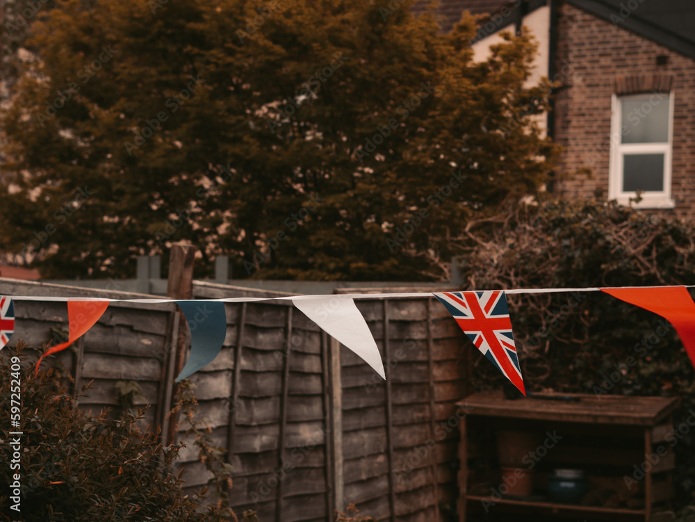 Flags of Great Britain waving on the wind in the garden of English ...