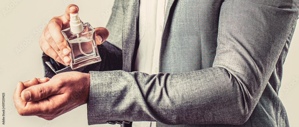 Fotografia do Stock: Men perfume in the hand on suit background. Man in ...
