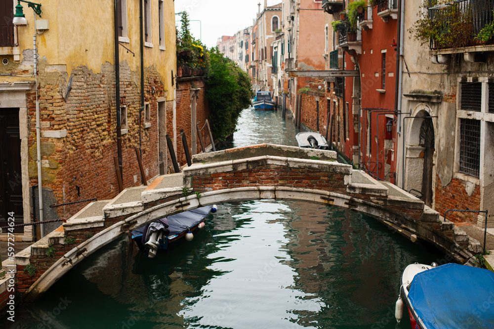 Cozy narrow canals of Venice city with old traditional architecture ...