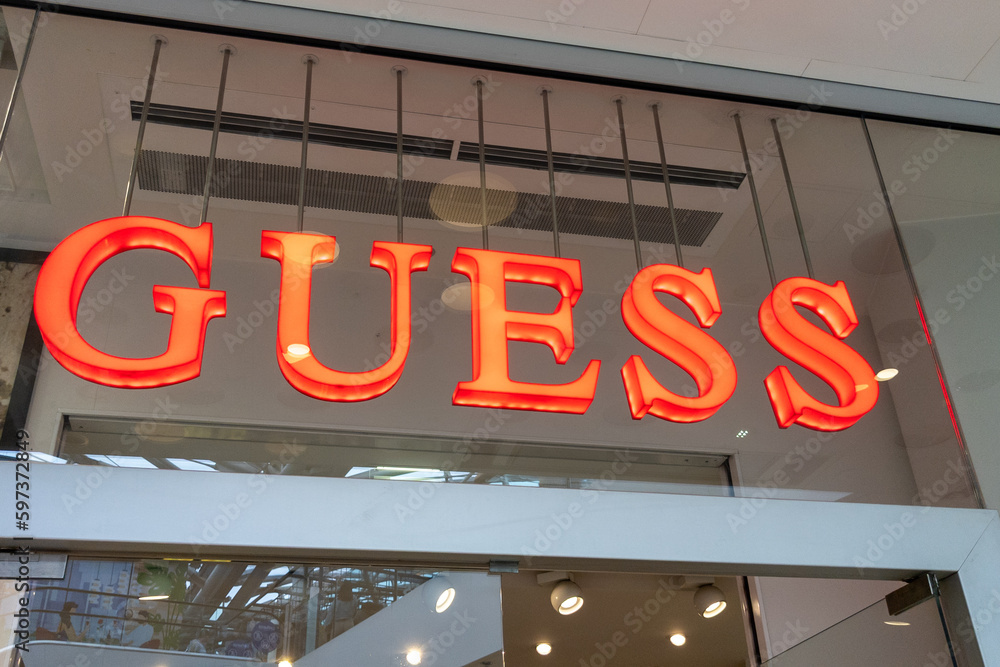 Guess storefront text and logo signboard shop sign on entrance facade ...