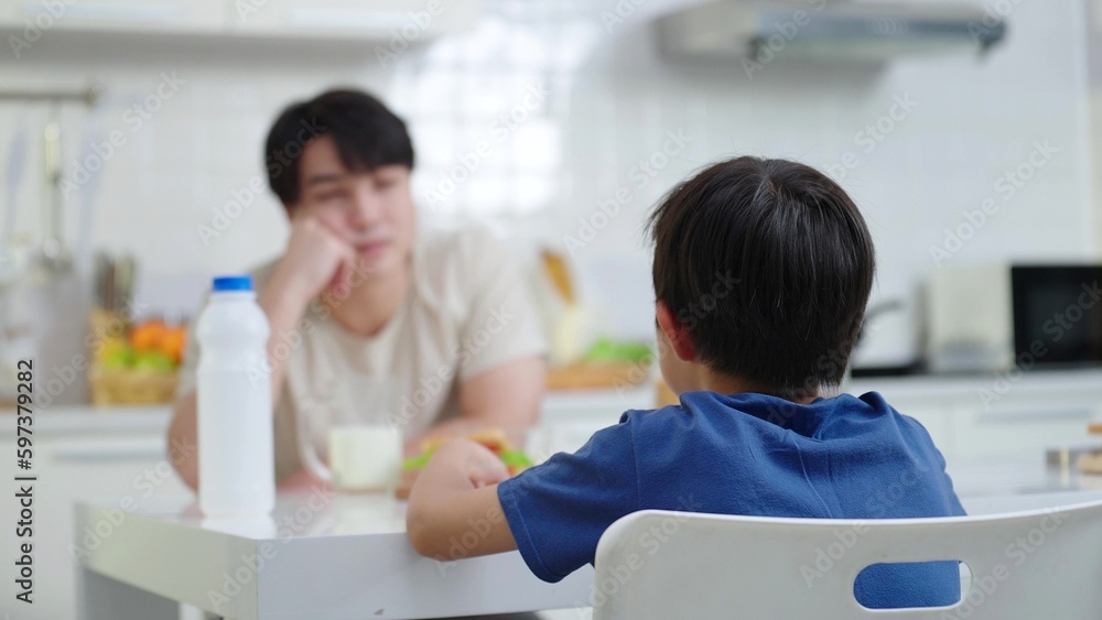 Asian father talking and scolding his son at home. Serious dad punish ...