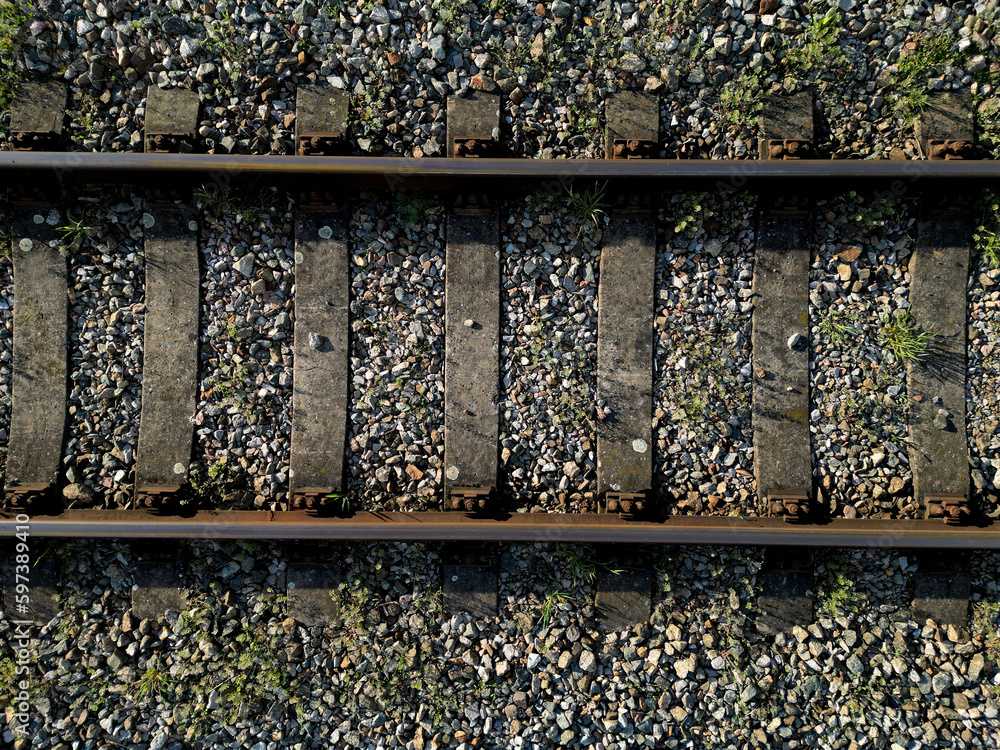 fly over train tracks in the countryside. vertical view of the ...