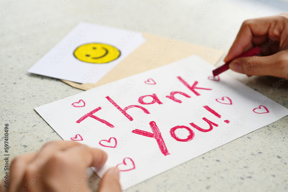Hand drawing a thank you message on a card Stock Photo | Adobe Stock