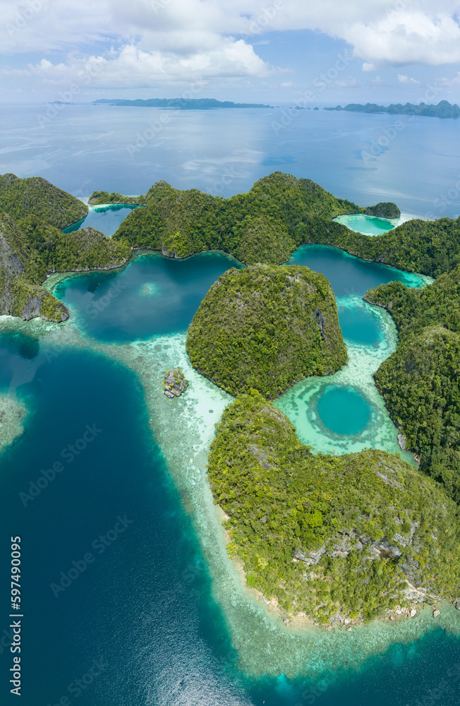 Beautiful coral reefs surround the dramatic limestone islands that rise ...