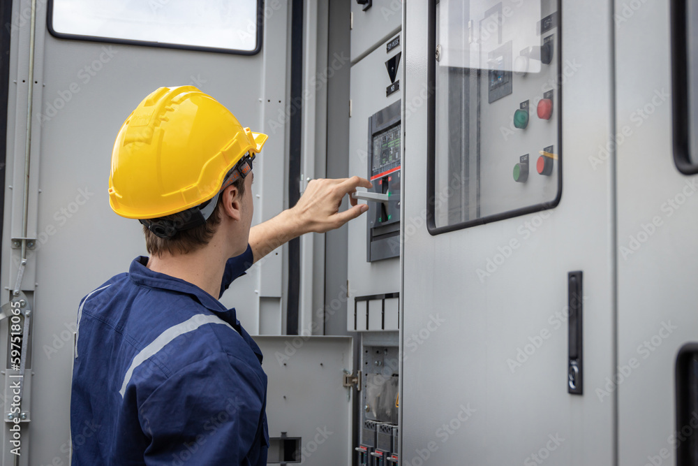 Electrical engineer working in control room. Electrical engineer man ...