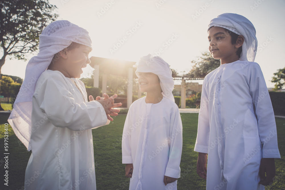 Children playing together in Dubai in the park. Group of kids wearing ...