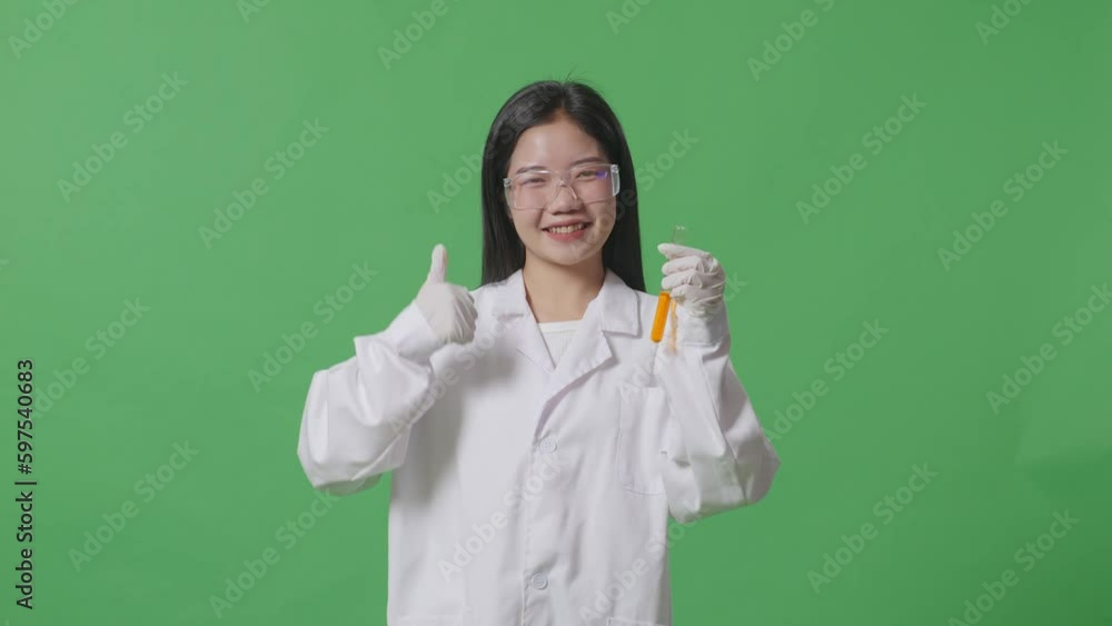 Asian Woman Scientist With Orange Liquid In The Test Tube Smiling And ...
