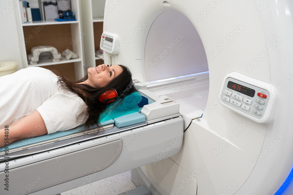 Photo Female patient undergoing MRI - Magnetic resonance imaging in ...