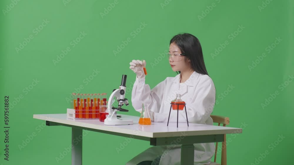 Side View Of Asian Woman Scientist Looking At Test Tube Then Thinking ...