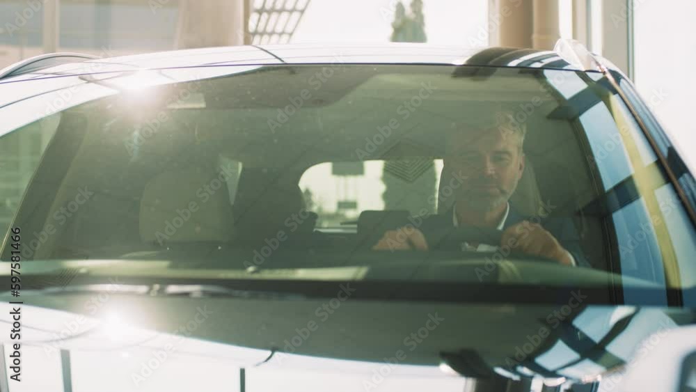 Handsome man happy after picking up new car from dealership. Modern ...