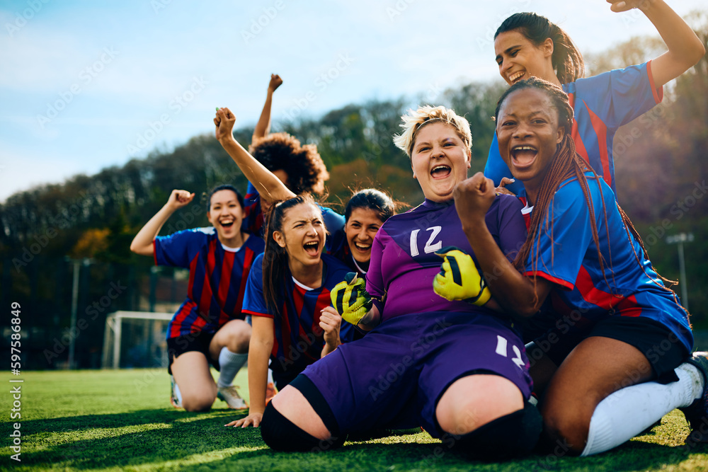 Cheerful goalkeeper and her teammates celebrate winning soccer match at ...