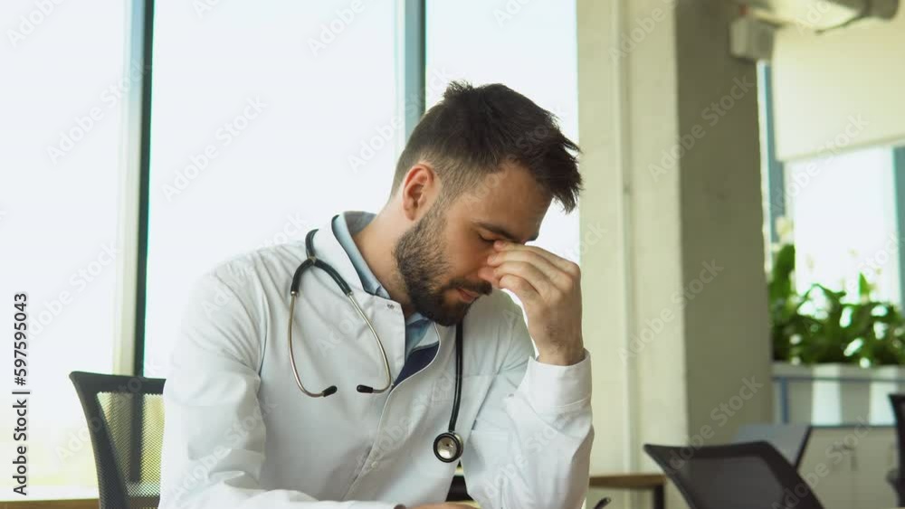 Stressed frustrated doctor wearing white uniform with stethoscope ...