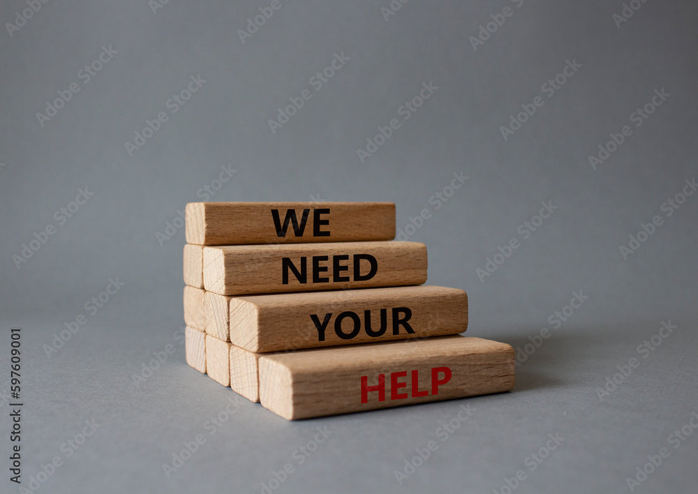 We need your help symbol. Wooden blocks with words We need your help ...