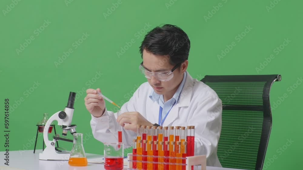 Side View Of Asian Man Scientist Making Experiment With Test Tube And ...
