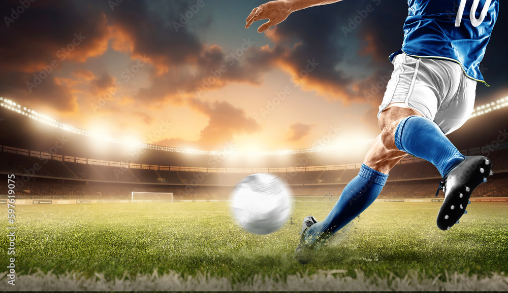 football soccer player kicking ball in action in blue team sunset ...