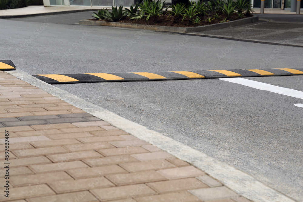 Striped speed bump on street. Road safety Stock Photo | Adobe Stock