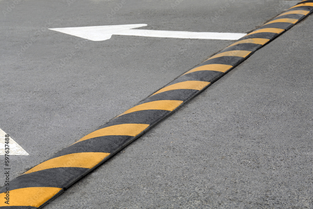 Striped speed bump on street. Road safety Stock Photo | Adobe Stock