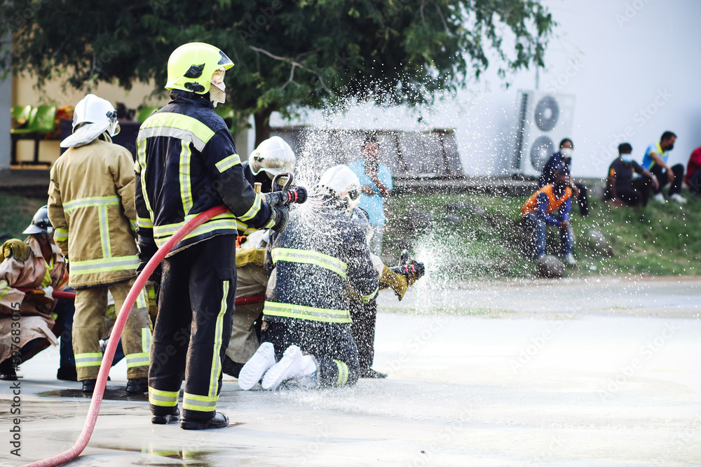 Firefighters using Twirl water fog type fire extinguisher to fighting ...