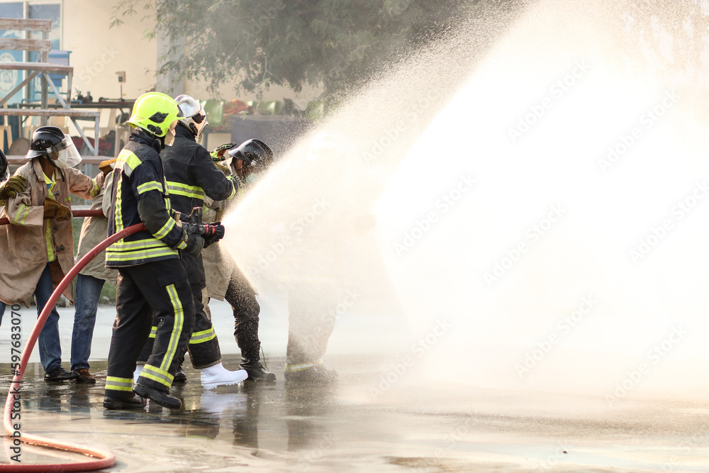 Firefighters using Twirl water fog type fire extinguisher to fighting ...