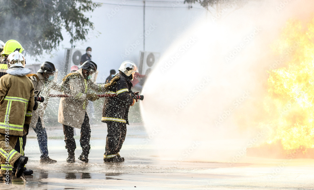 Firefighters using Twirl water fog type fire extinguisher to fighting ...
